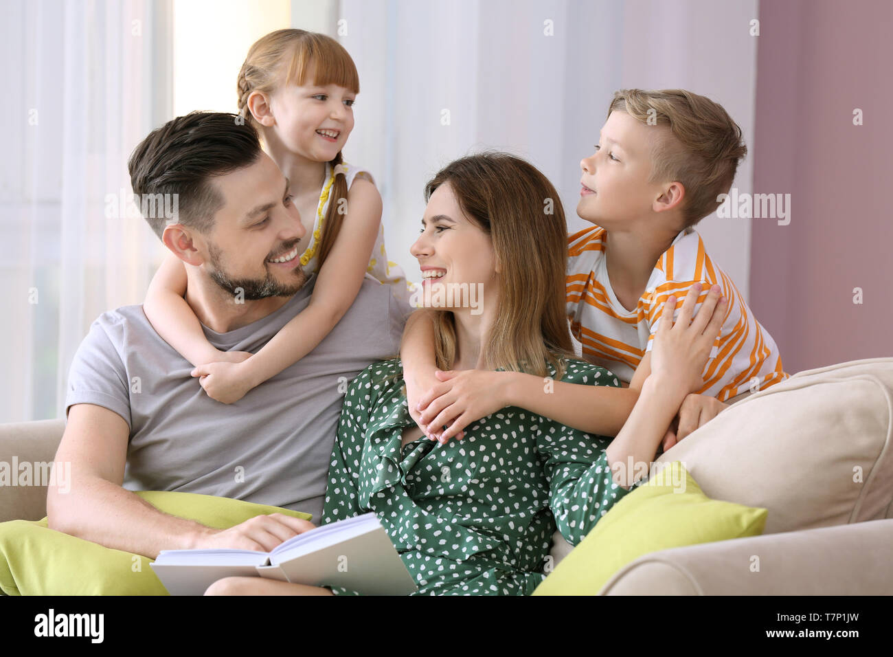 Happy family reading book together at home Stock Photo - Alamy