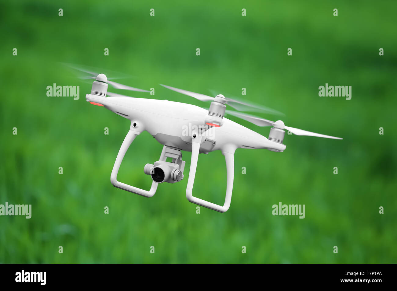 Flying quadcopter over grass hi-res stock photography and images - Alamy