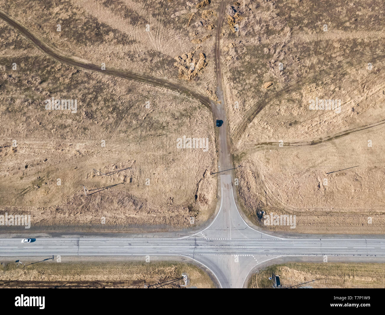 Aerial view of the intersection of asphalt and ground roads in the ...