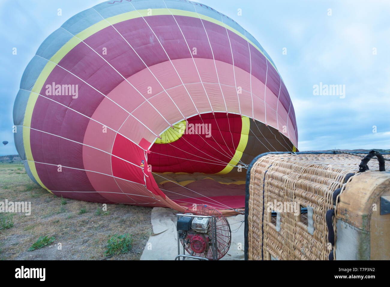 Cappadocia, Goreme, Turkey. People inflate balloons with a gas burner ...