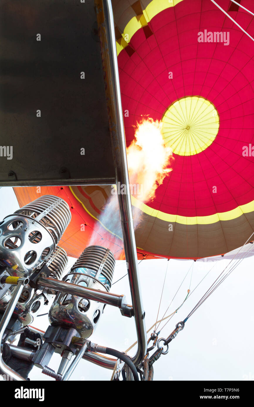 The balloon is blown inflate with fire from the torch, a long flame ...