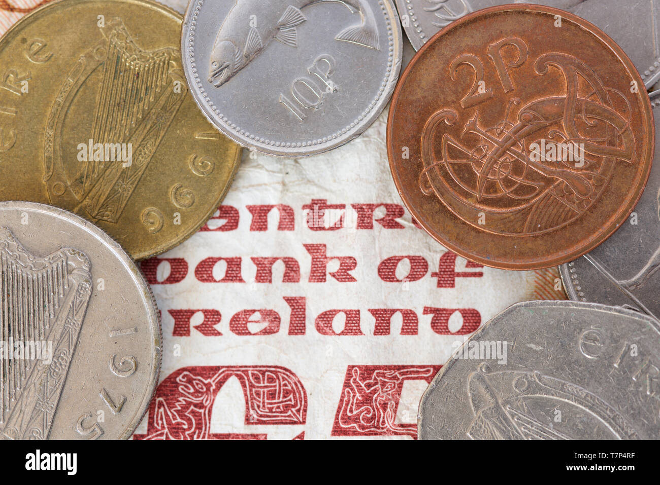 Various coins from Ireland on top of a 5 pound note Stock Photo - Alamy