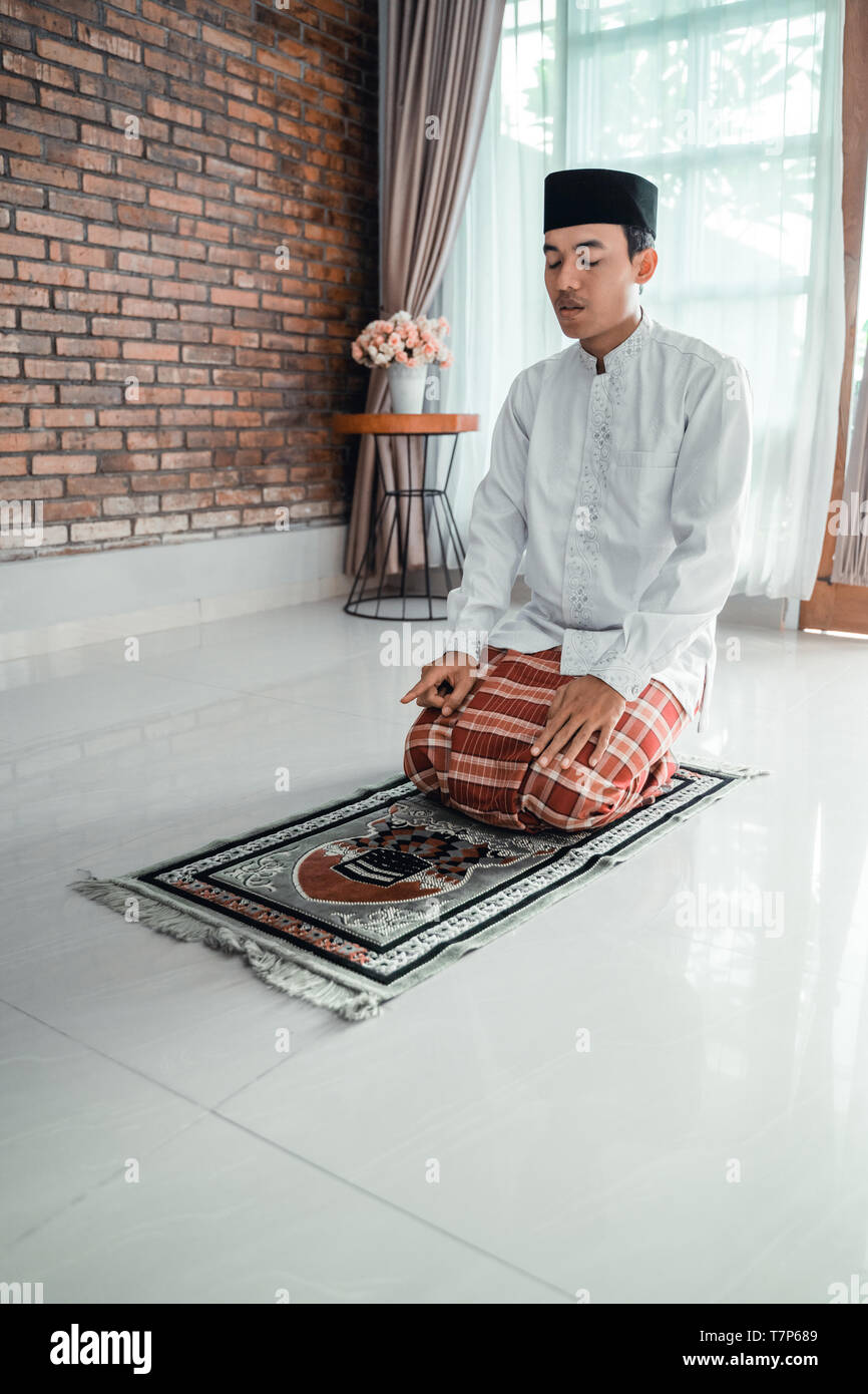 muslim asian man praying to god Stock Photo - Alamy