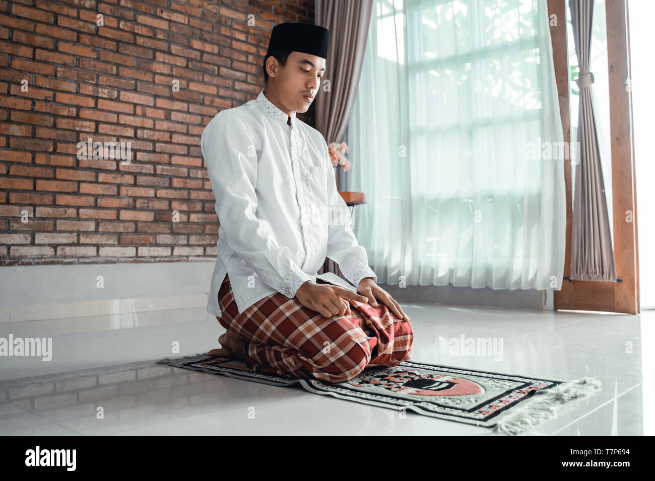muslim asian man praying to god Stock Photo - Alamy