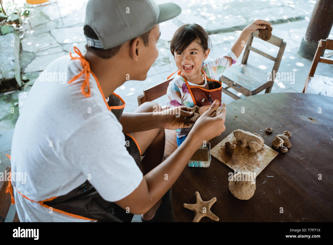 Child working with clay making pottery Stock Photo - Alamy