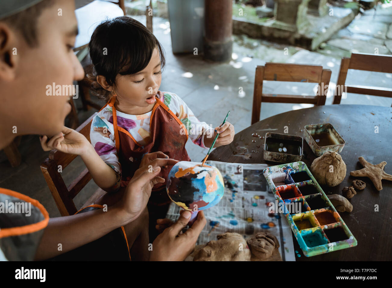 Child pottery painting hi-res stock photography and images - Alamy