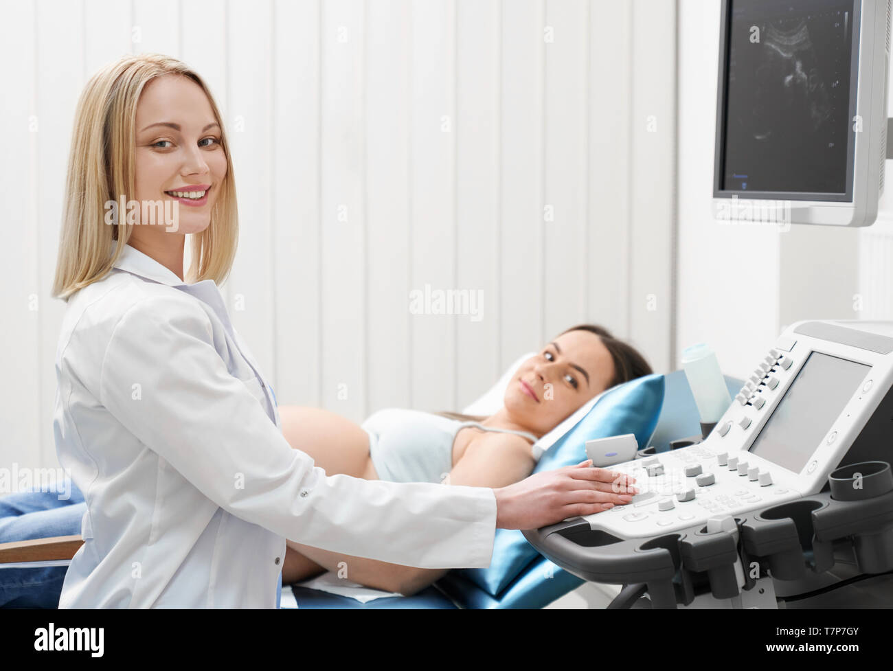 Side view of professional female doctor looking at camera and smiling ...