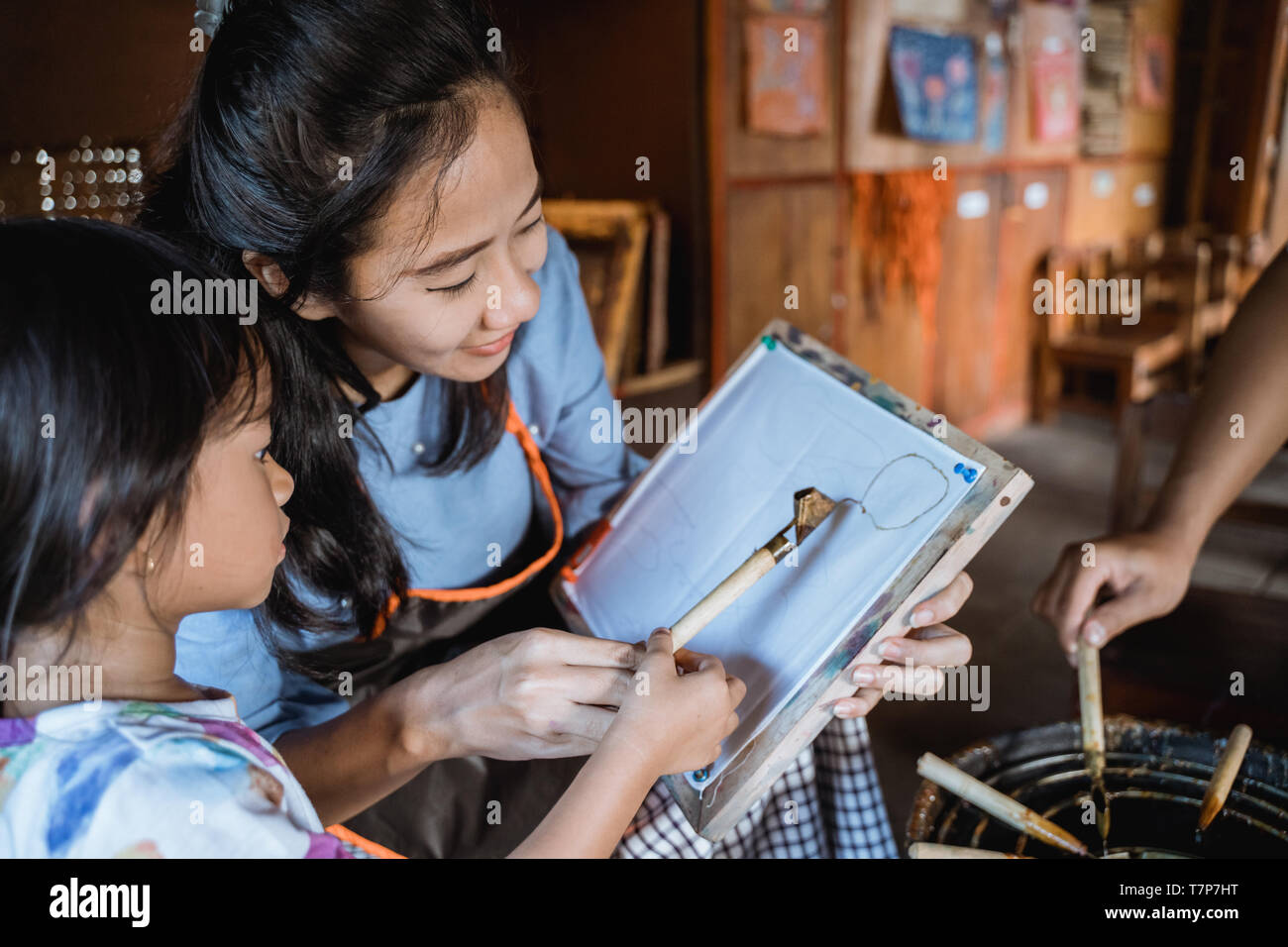 mother and child asian making batik pattern Stock Photo - Alamy