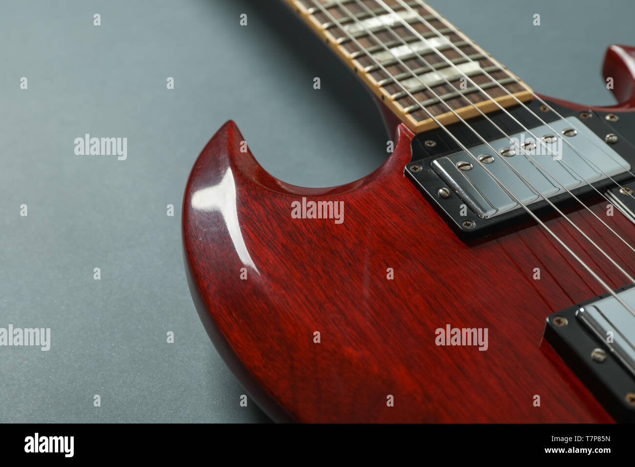 Beautiful six - string electric guitar on dark background, closeup ...