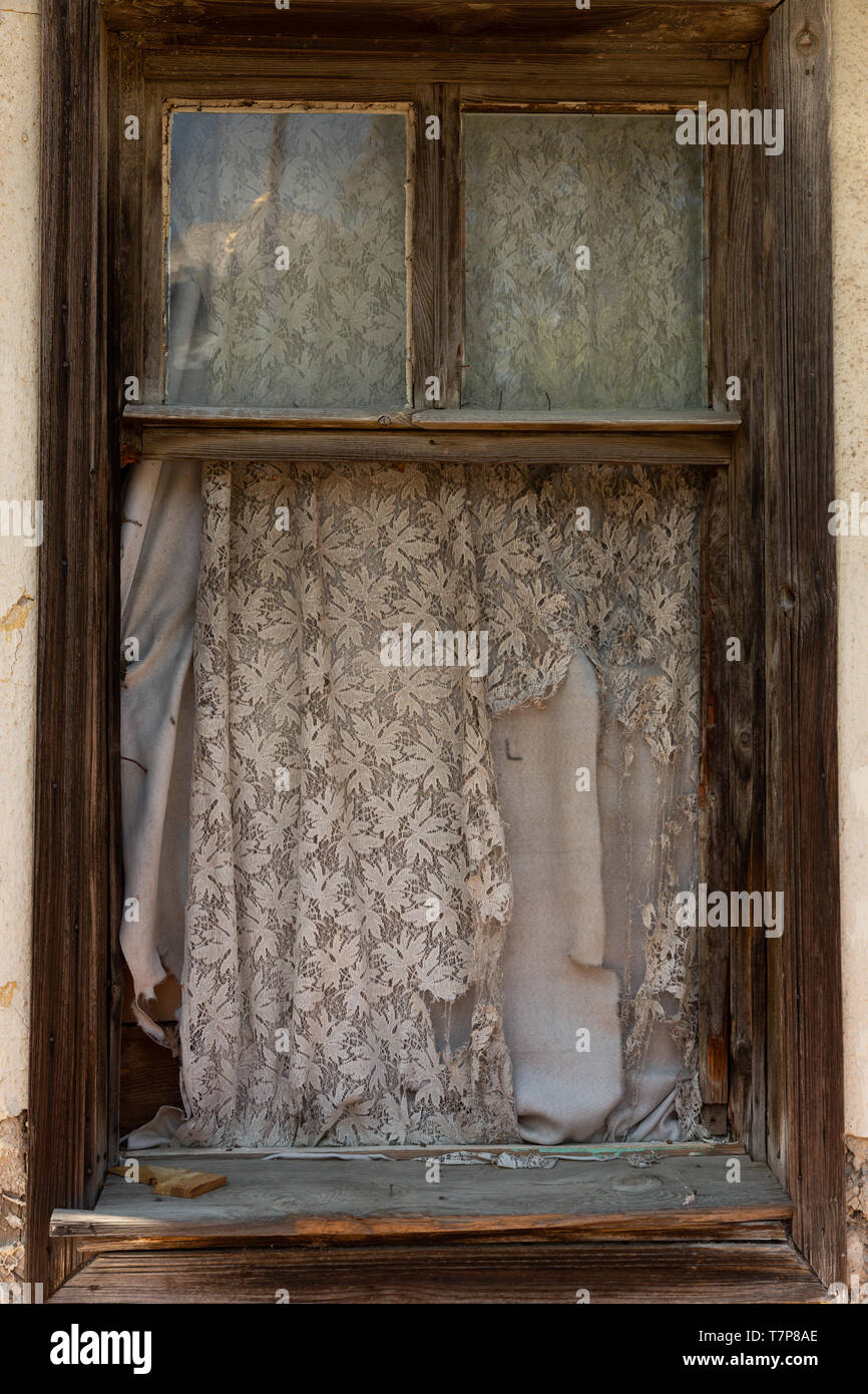tattered curtain at a glassless window in an abandoned house Stock ...