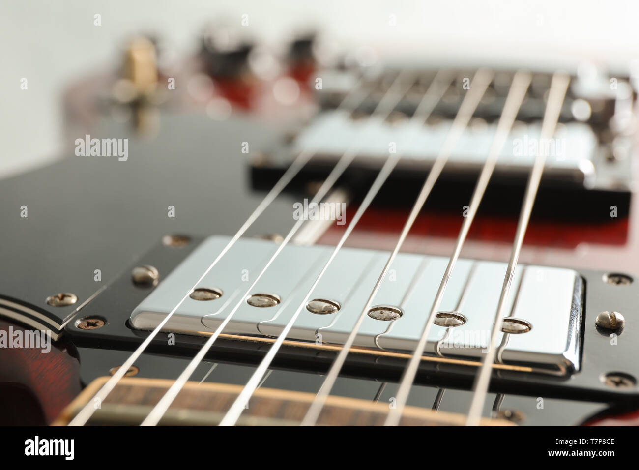 Beautiful six - string electric guitar on white background, closeup ...