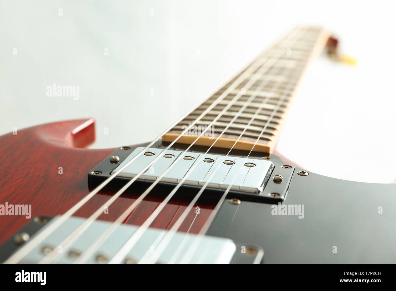 Beautiful six - string electric guitar on white background, closeup ...