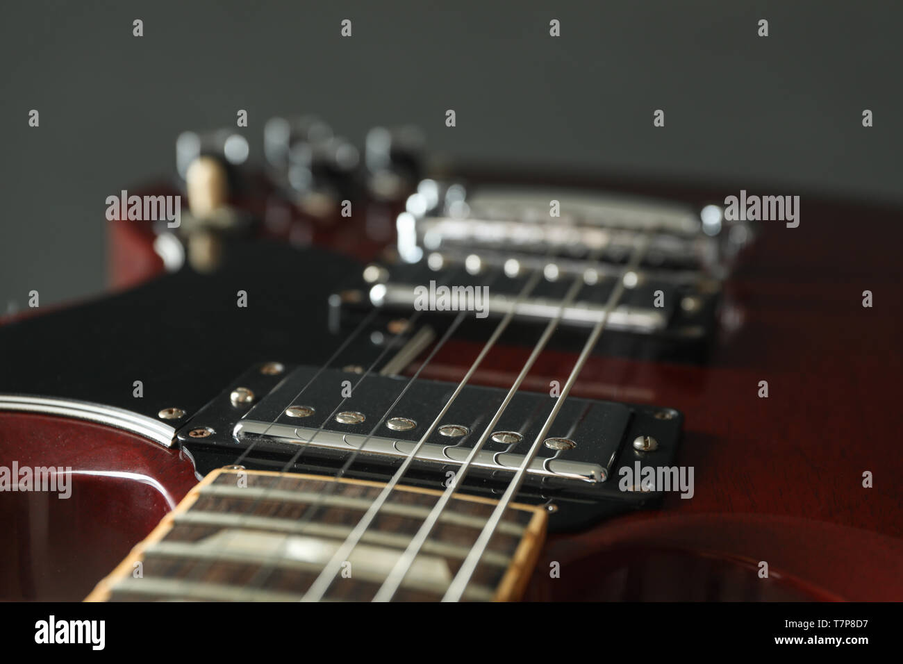 Beautiful six - string electric guitar against dark background, closeup ...