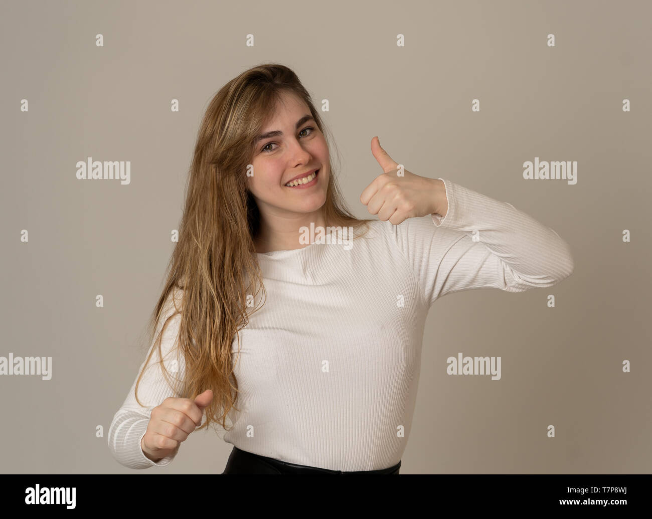 Studio portrait of young beautiful teenager girl woman looking happy ...