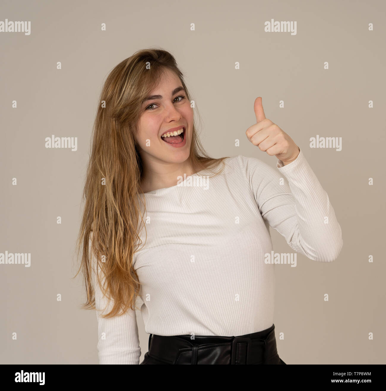 Studio portrait of young beautiful teenager girl woman looking happy ...