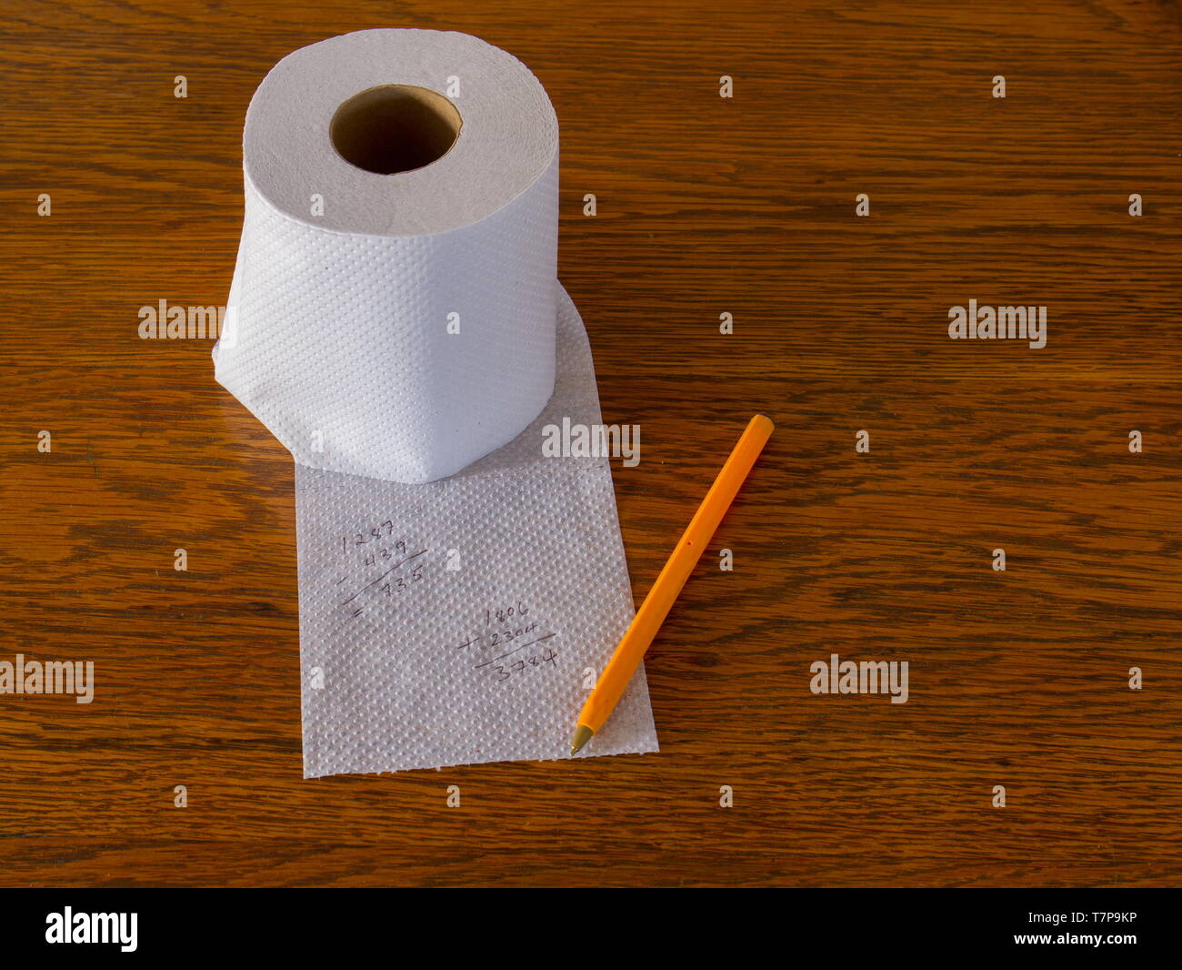 Incorrect math calculations on white toilet paper isolated on a wooden ...