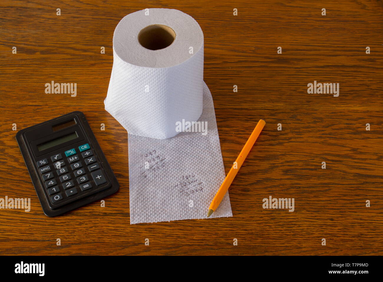 Incorrect math calculations on white toilet paper isolated on a wooden ...