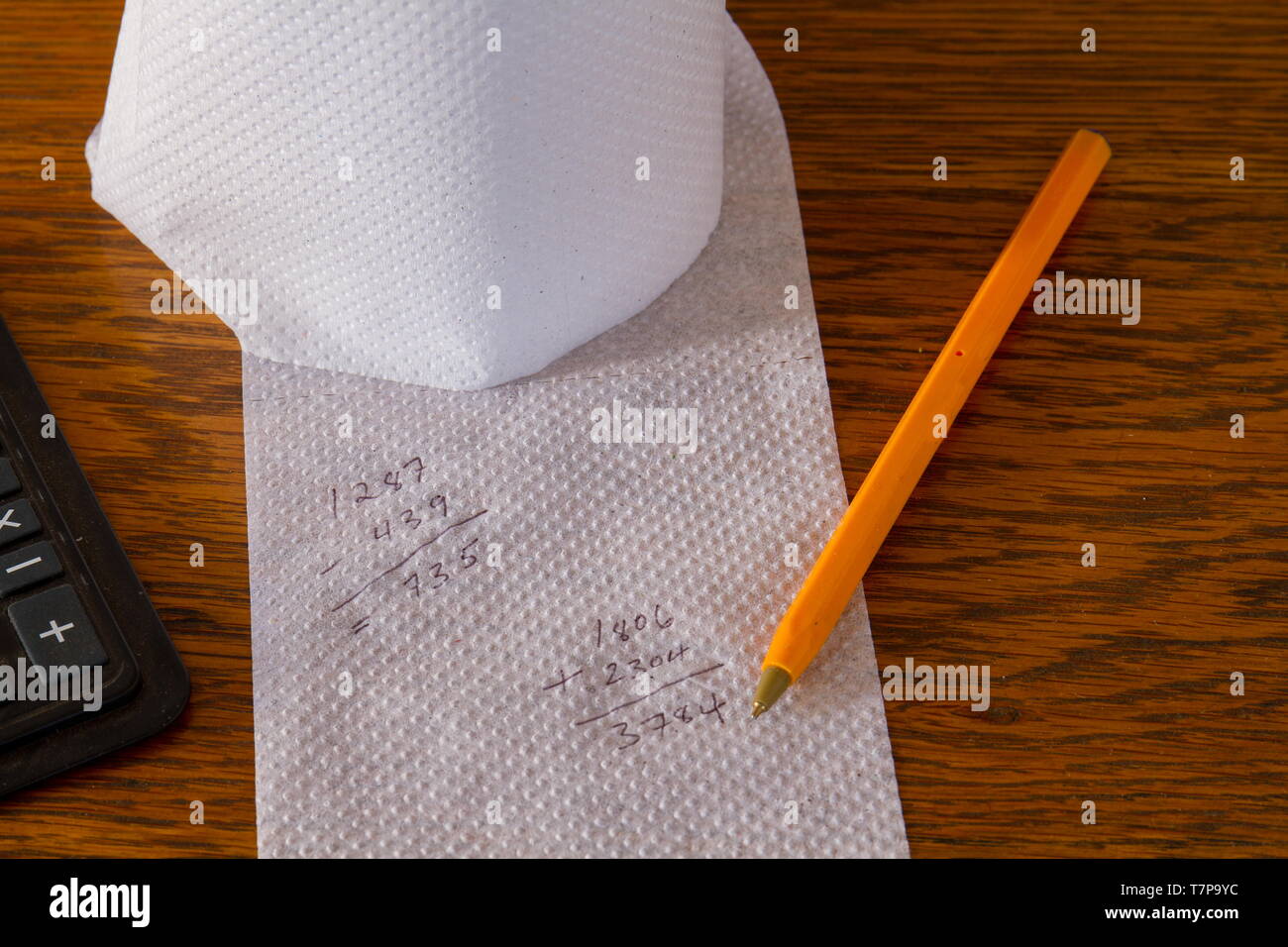 Incorrect math calculations on white toilet paper isolated on a wooden ...