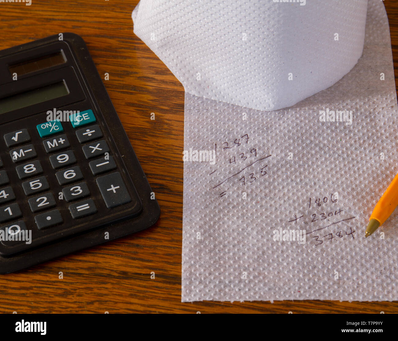 Incorrect math calculations on white toilet paper isolated on a wooden ...