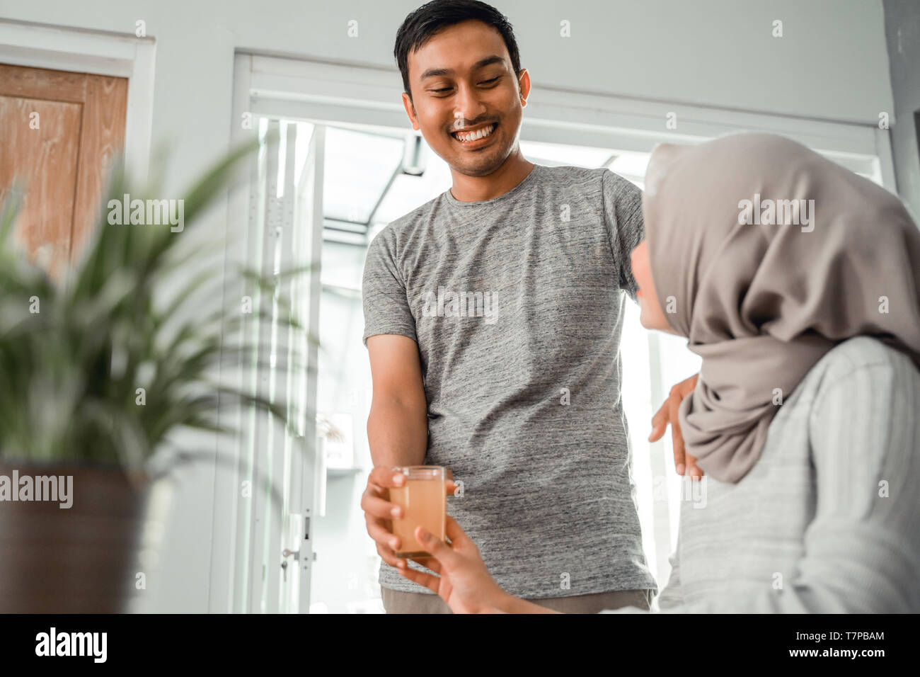husband giving drink to his wife Stock Photo - Alamy