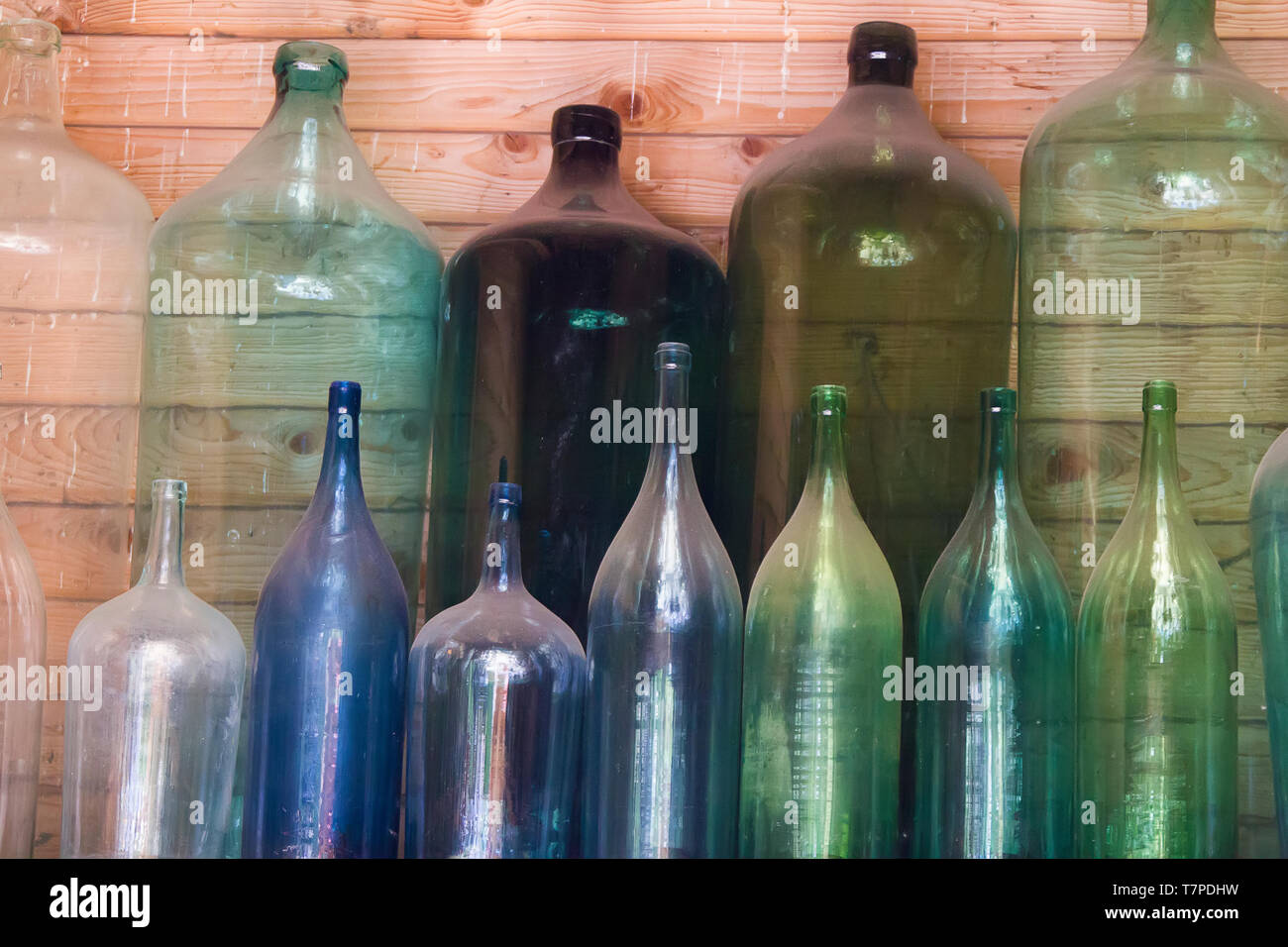 Glass multi-colored wine bottles dusty Stock Photo - Alamy