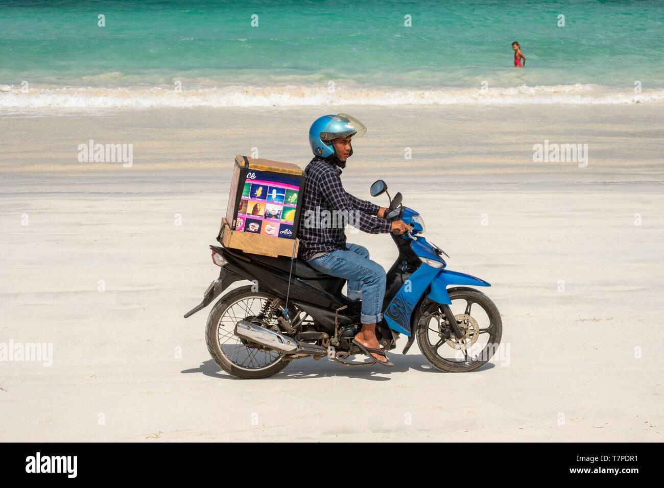Indonesia, Lombok, Kuta area, Tanjung Ann beach, ambulant motorcycle ...