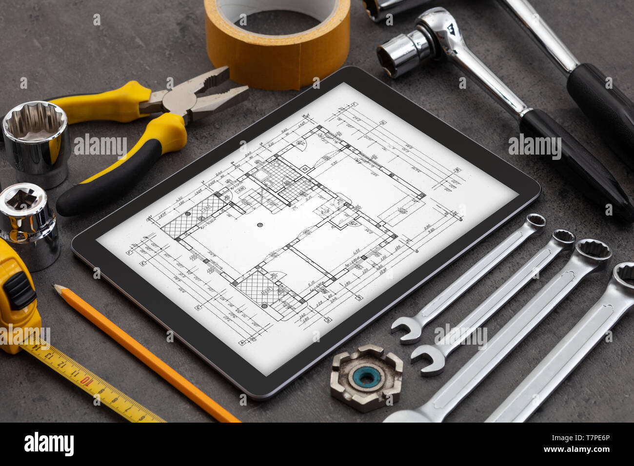 Tablet with construction tools and blueprint concept Stock Photo - Alamy