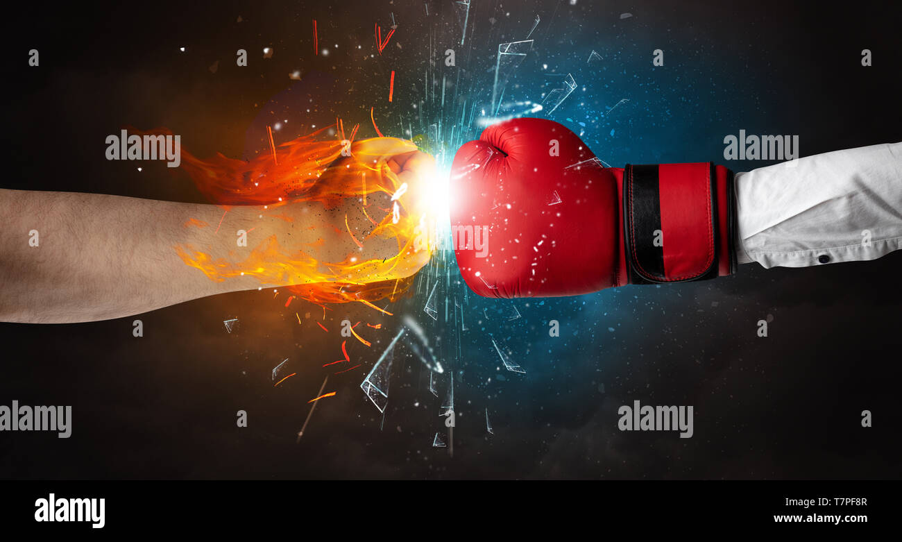 Two hands fighting and breaking glass into small pieces with fire and ...