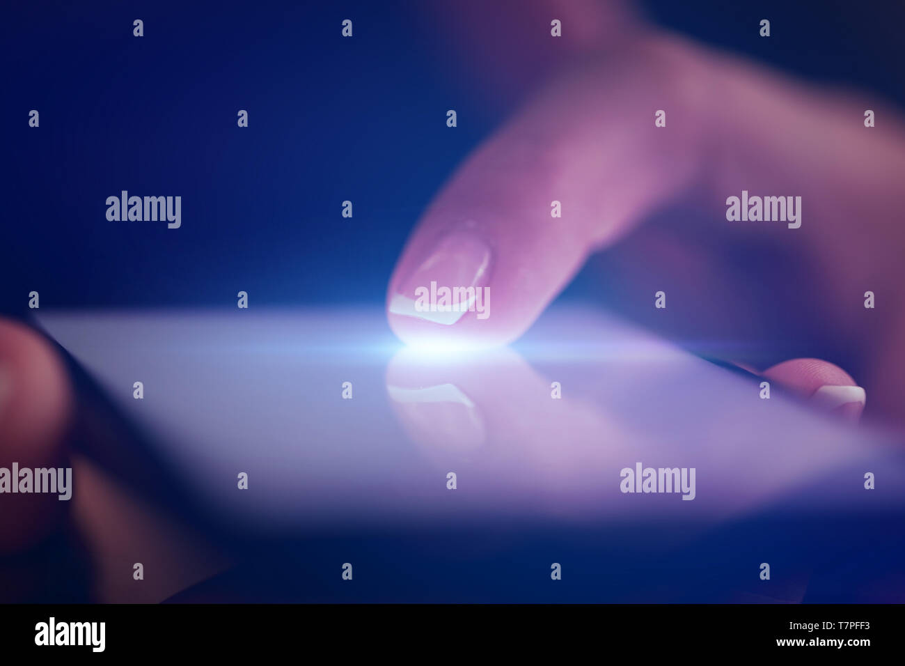 Finger touching phone with dark background with copyspace Stock Photo ...