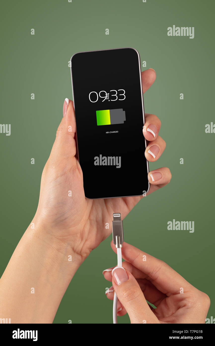 Elegant hand charging smartphone with low battery Stock Photo - Alamy