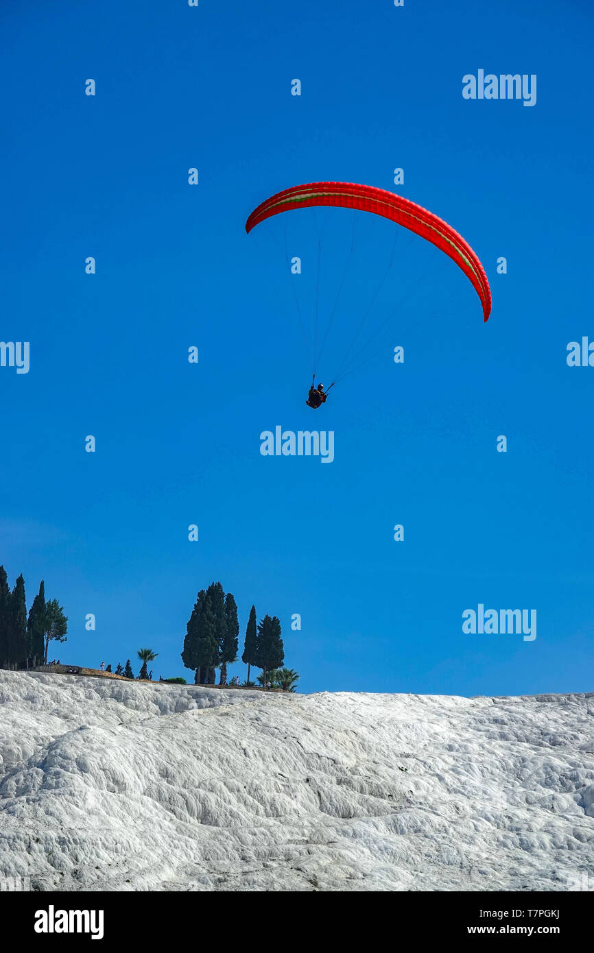 Parapent, parachute, flying over white travertine, Pamukkale, Turkey ...