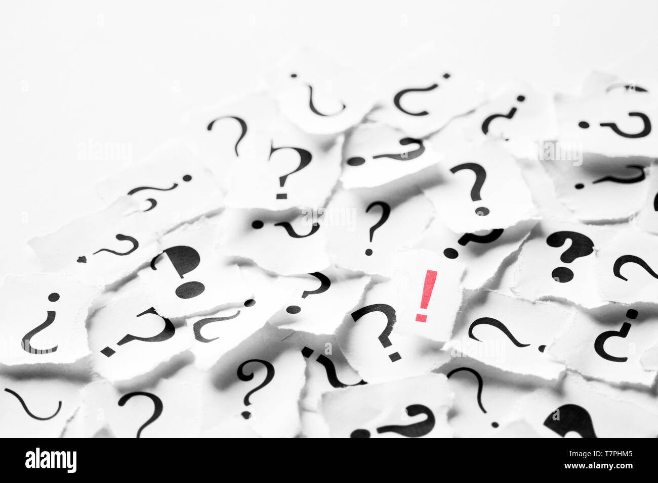 Pile of question mark signs scattered around with one red exclamation ...