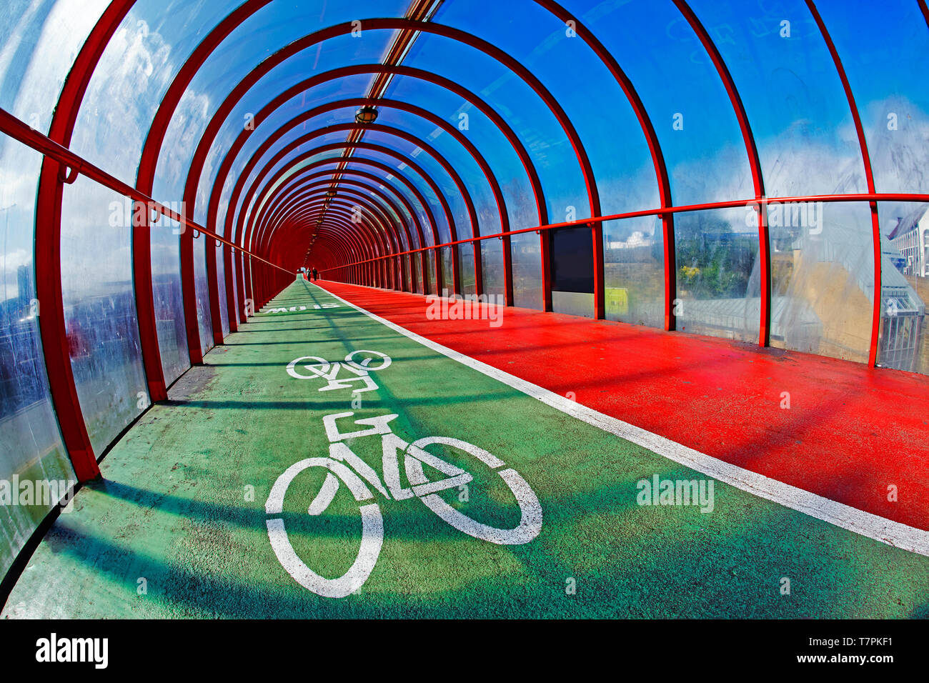 Interior of red tunnel with cycle path and pedestrian bridge in Glasgow ...