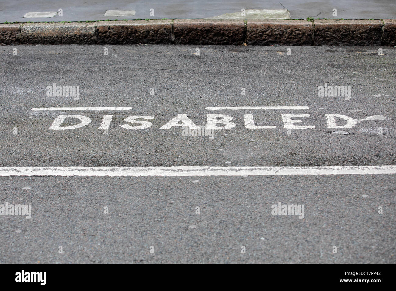 Word DISABLED written on asphalt Stock Photo - Alamy