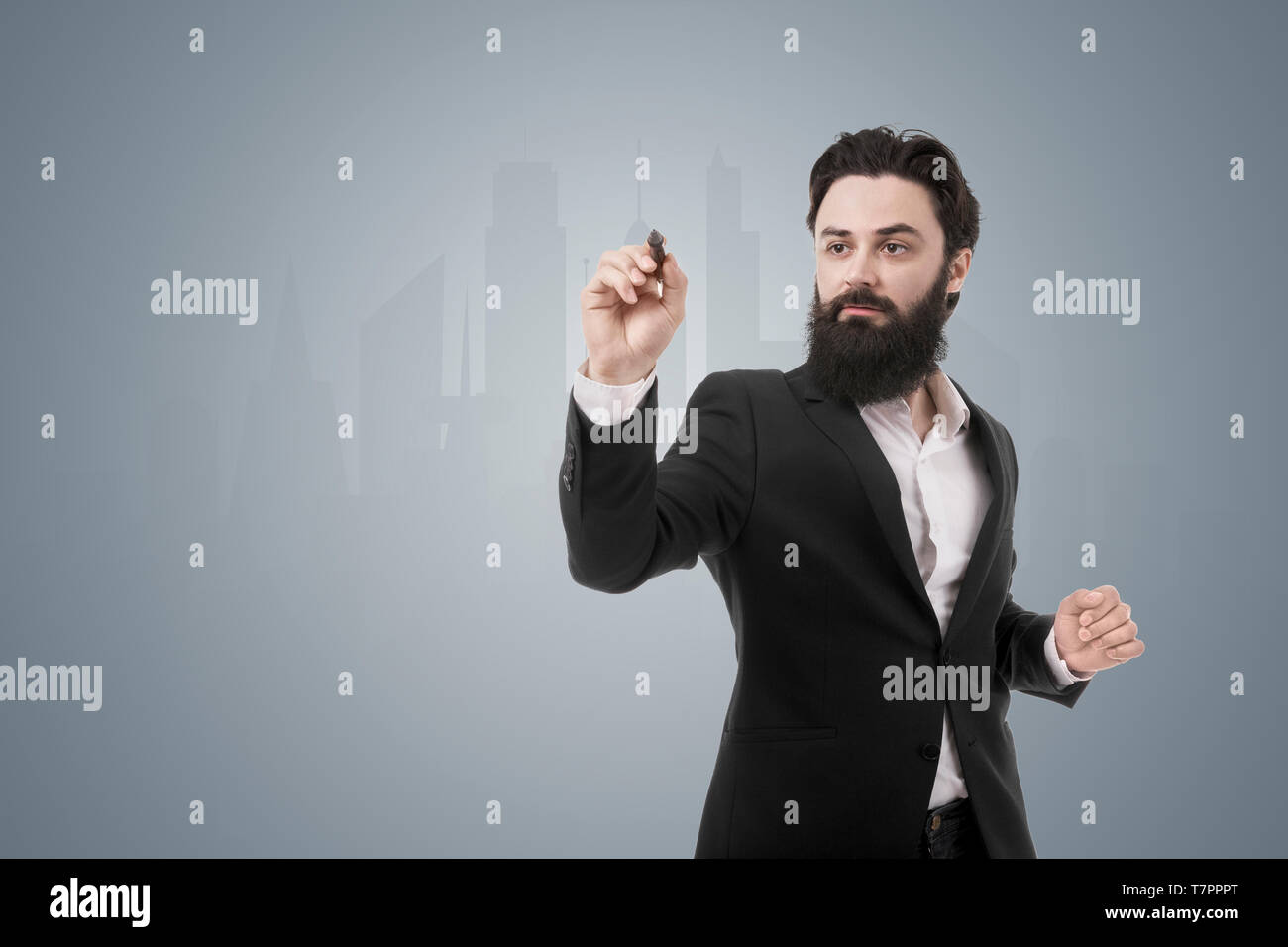 portrait of a bearded architect drawing with stylus over modern city ...