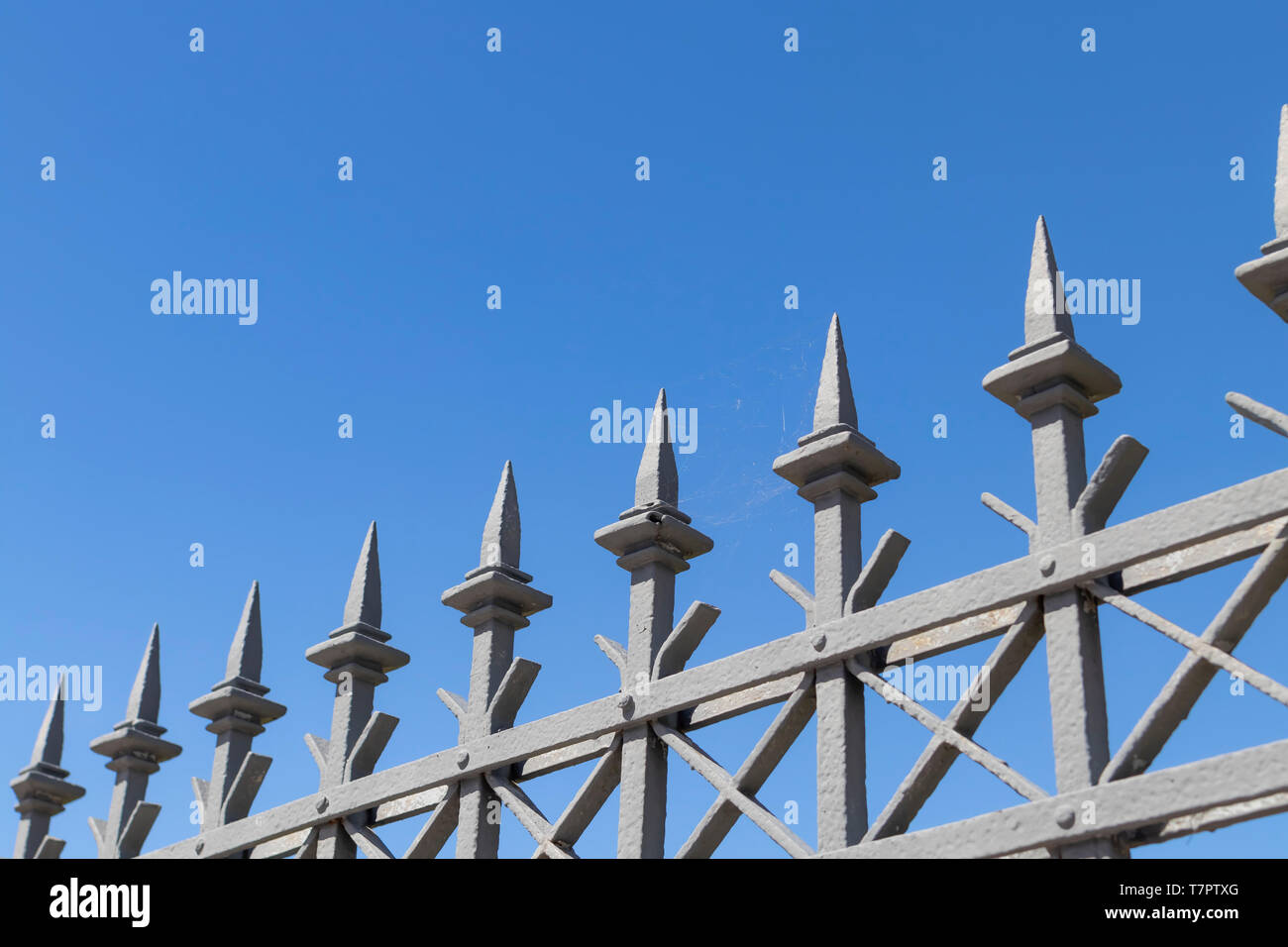 Patterned metal fence with peaks around the perimeter of the old prison ...