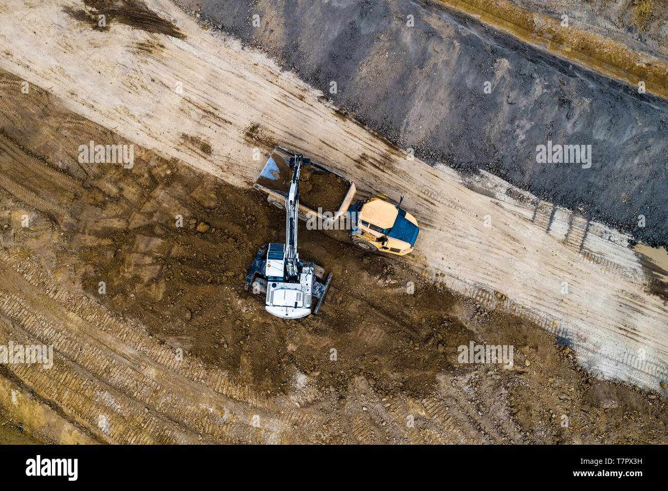 Excavator loader loading ground on truck. Road construction Stock Photo ...