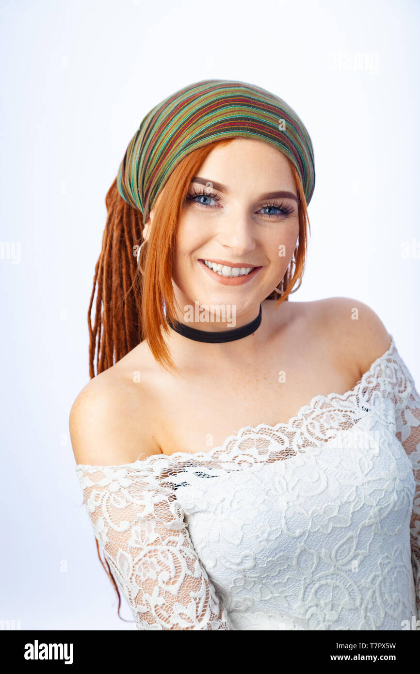 Portrait pf a beautiful red headed woman with dreadlocks and wearing a ...