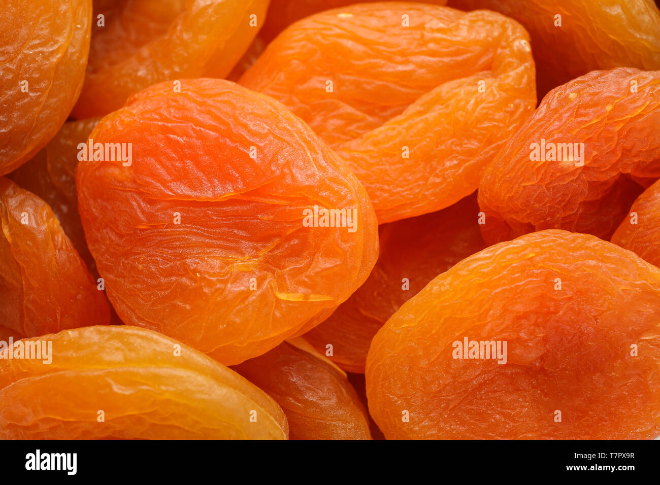 Delicious dried apricot fruit as background, closeup Stock Photo - Alamy