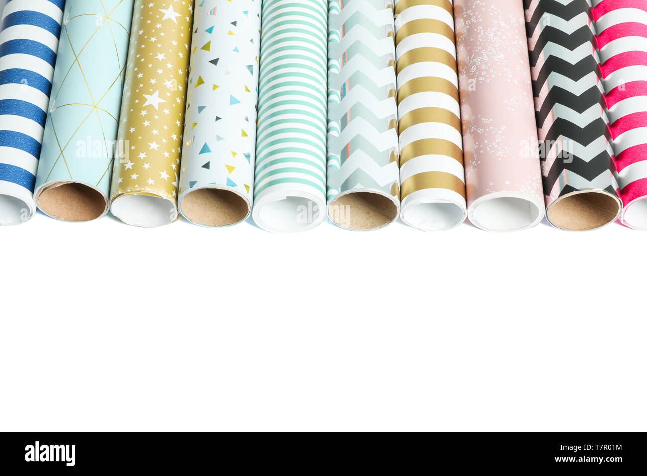Rolls of festive wrapping paper on white background. Space for text ...