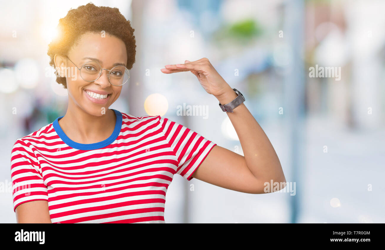 Beautiful young african american woman wearing glasses over isolated ...