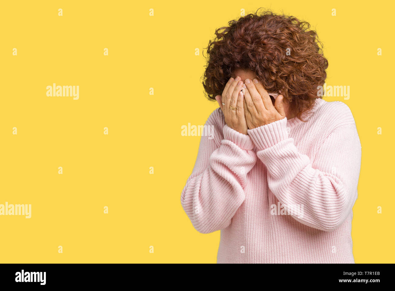 Beautiful middle ager senior woman wearing pink sweater and sunglasses ...