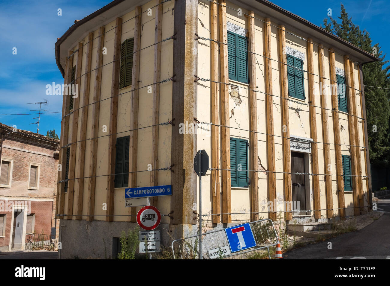 A large apartment block in an Italian village that has been damaged by ...