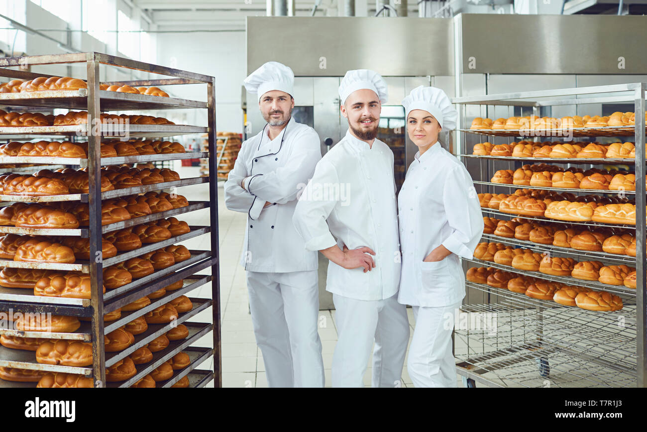 A team of bakers smiles at the bakery Stock Photo - Alamy