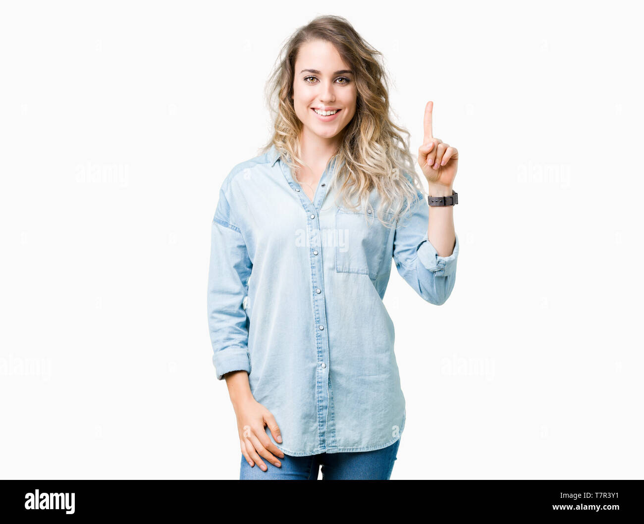 Beautiful young blonde woman over isolated background showing and ...