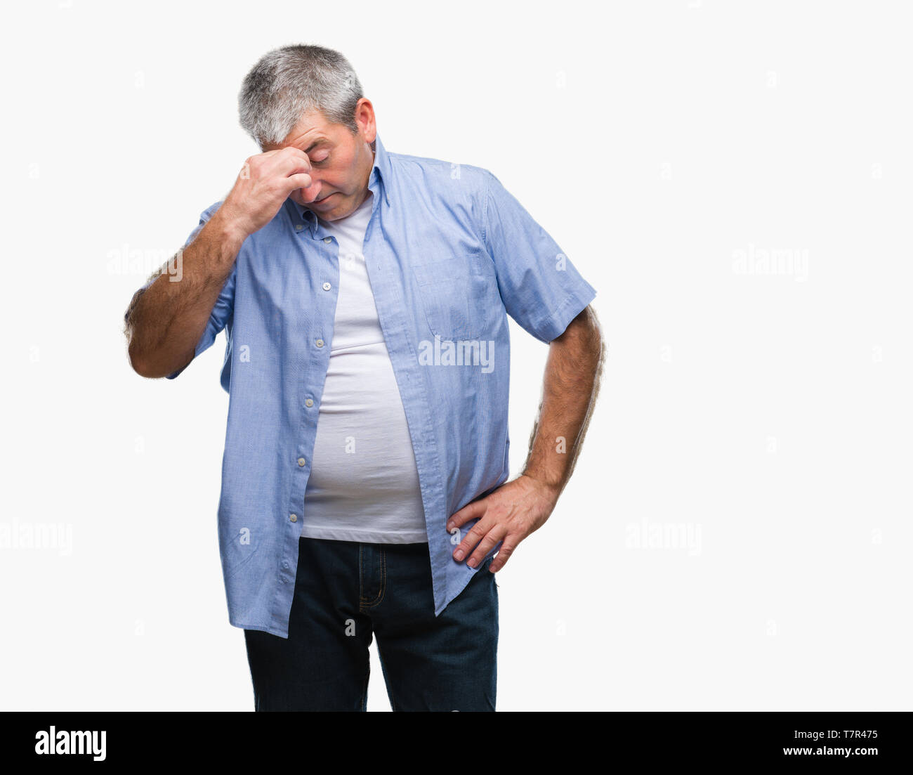 Handsome senior man over isolated background tired rubbing nose and ...