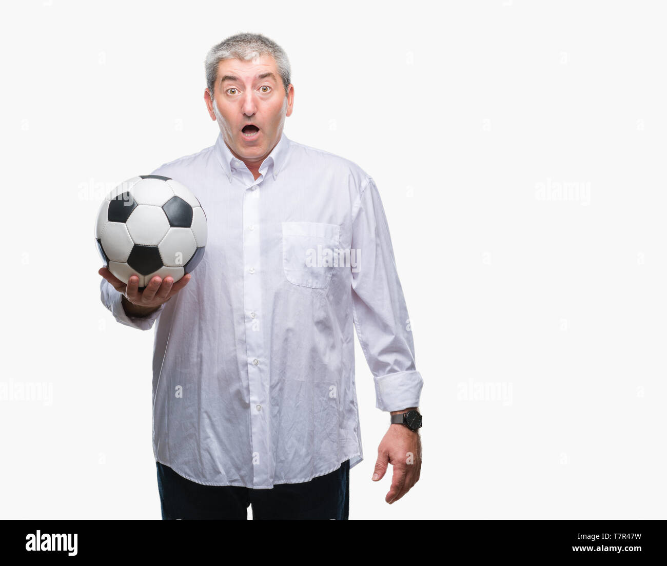 Handsome senior man holding soccer football ball over isolated ...