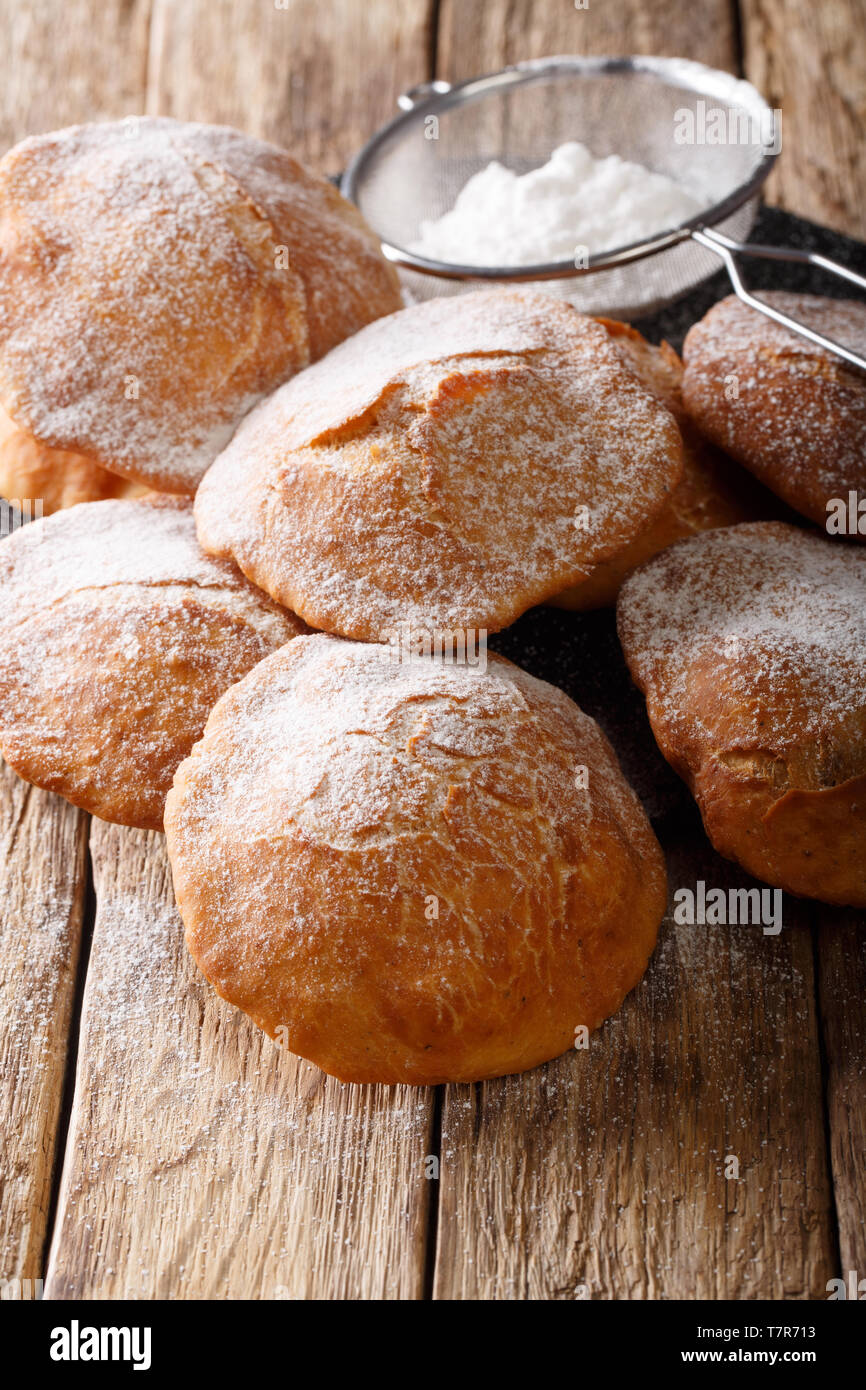 Bunuelos Mexican fritters sprinkled with powdered sugar close-up on the ...