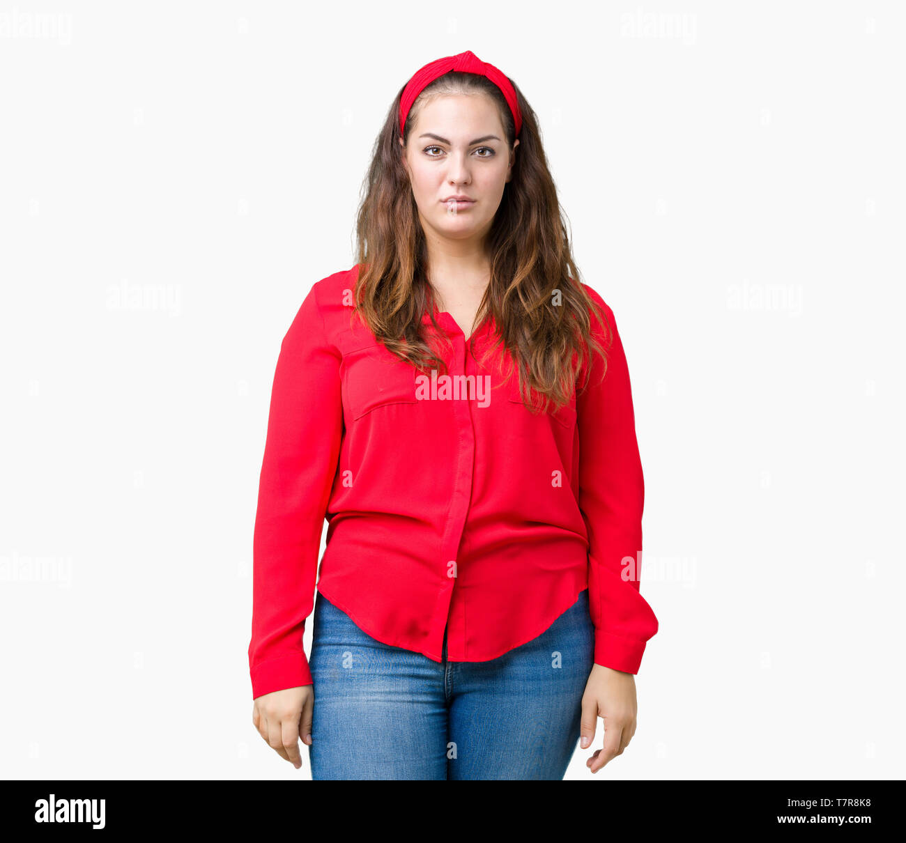 Beautiful plus size young woman over isolated background with serious ...