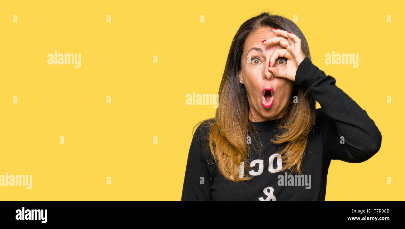 Beautiful middle age woman wearing rock and roll sweater doing ok ...